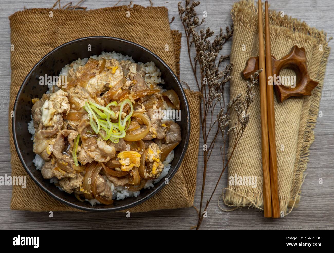 Japanese pork rice bowl with egg and onion (Donburi) served with ...