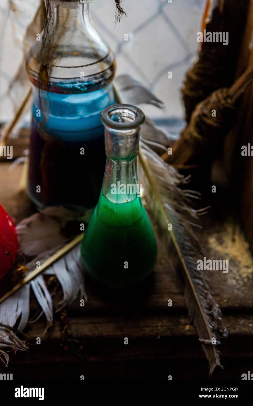 Magic potions in bottles near old rustic window with backlight ...