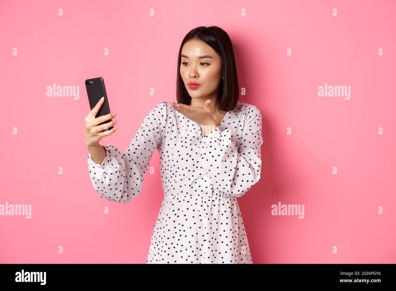 Beautiful asian girl using photo filters app and taking selfie on ...