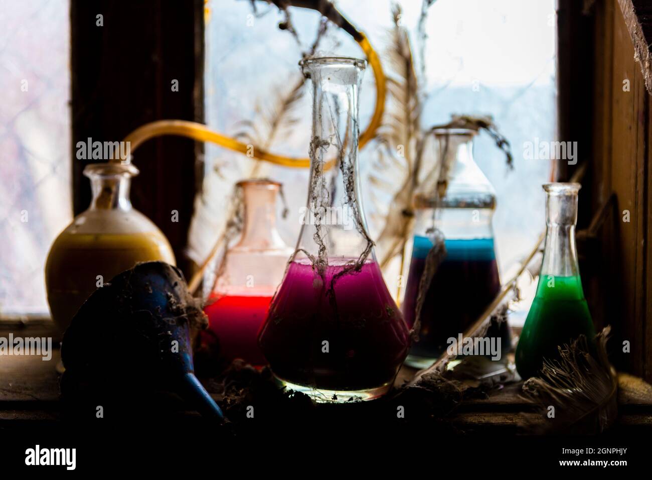 Magic potions in bottles near old rustic window with backlight ...