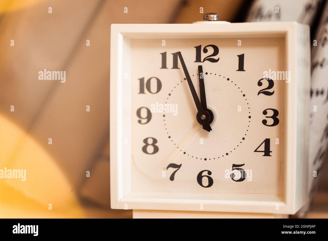 White vintage clock and pile of books Stock Photo - Alamy
