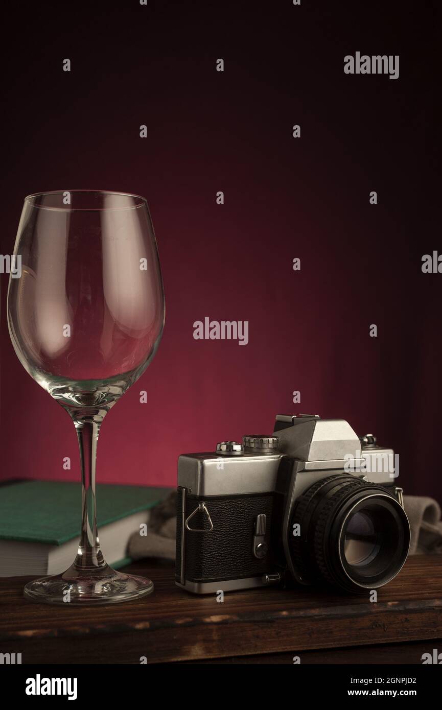 Wine glass and analog camera on the wooden table Stock Photo - Alamy