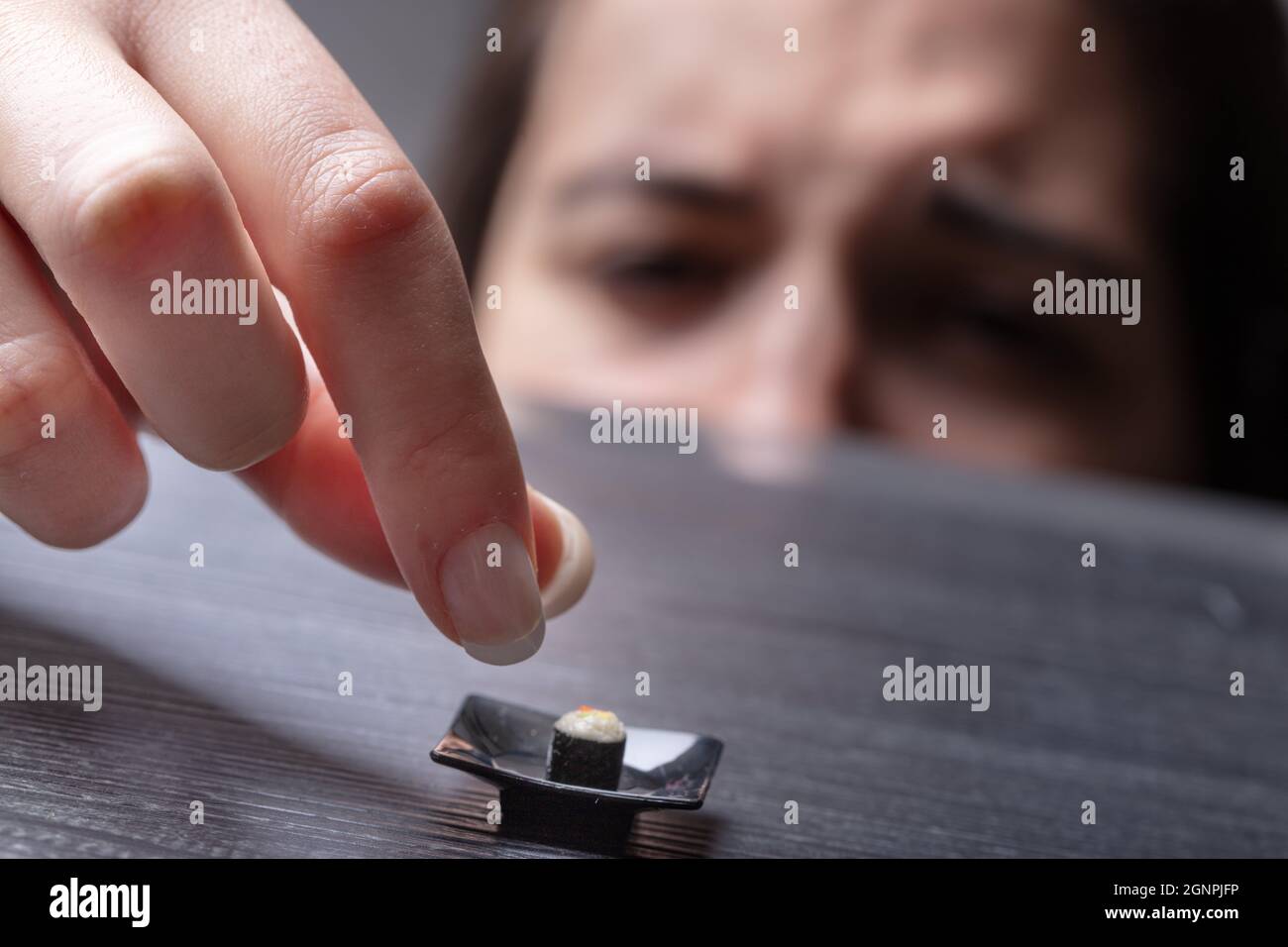 saddened face on blurred background, in the foreground hand of a woman ...