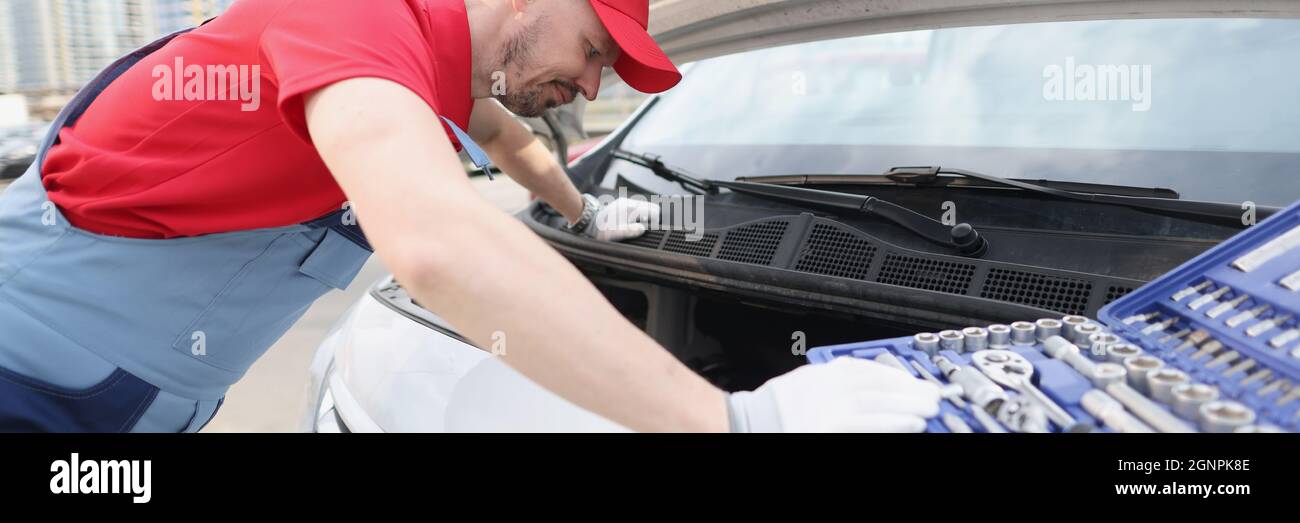 Man repairman fixing car using steel tools Stock Photo - Alamy