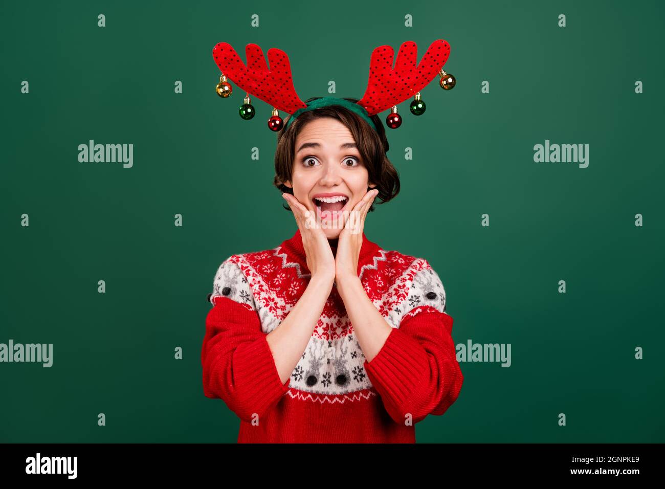 Portrait of attractive amazed cheerful girl wearing festal look holly ...
