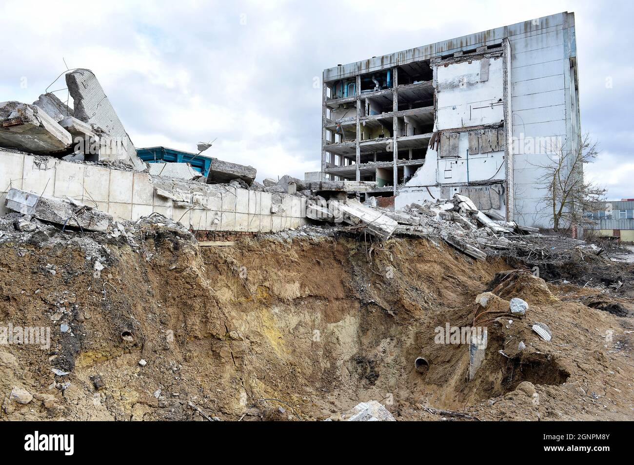 Ruins of a destroyed house, pieces of metal and stone, a crater from ...