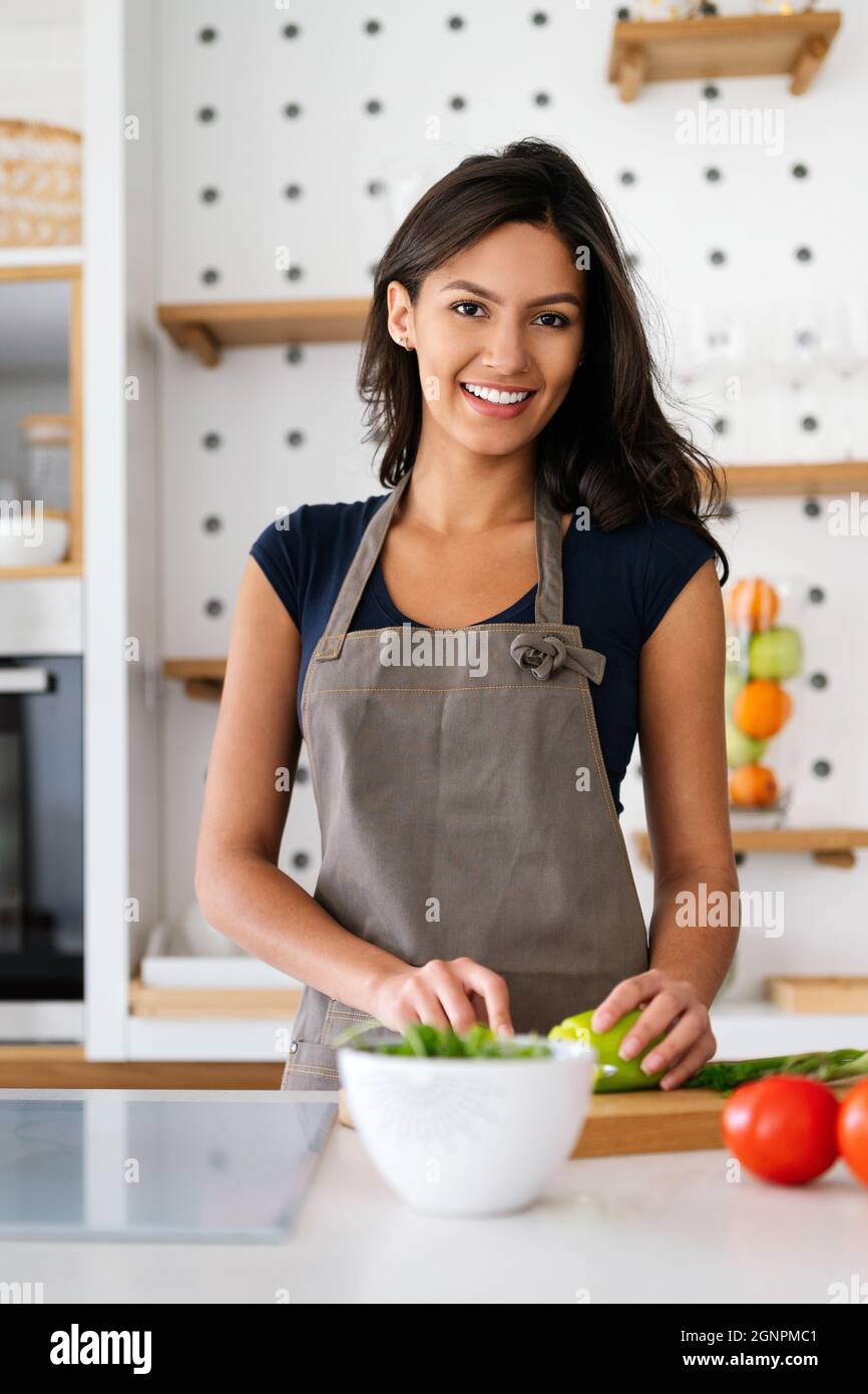 Beautiful woman having fun cooking in kitchen at home Stock Photo - Alamy