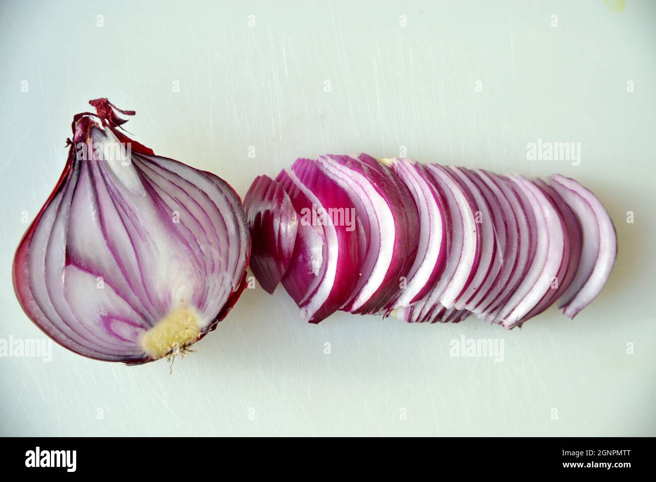Chopped red onion on a white kitchen board Stock Photo - Alamy