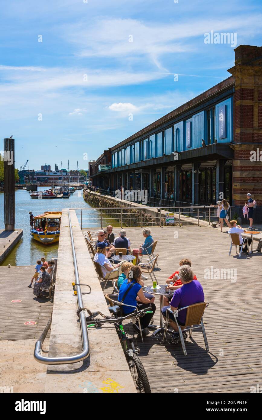 Bristol Waterfront, view in summer of people relaxing at a cafe terrace ...