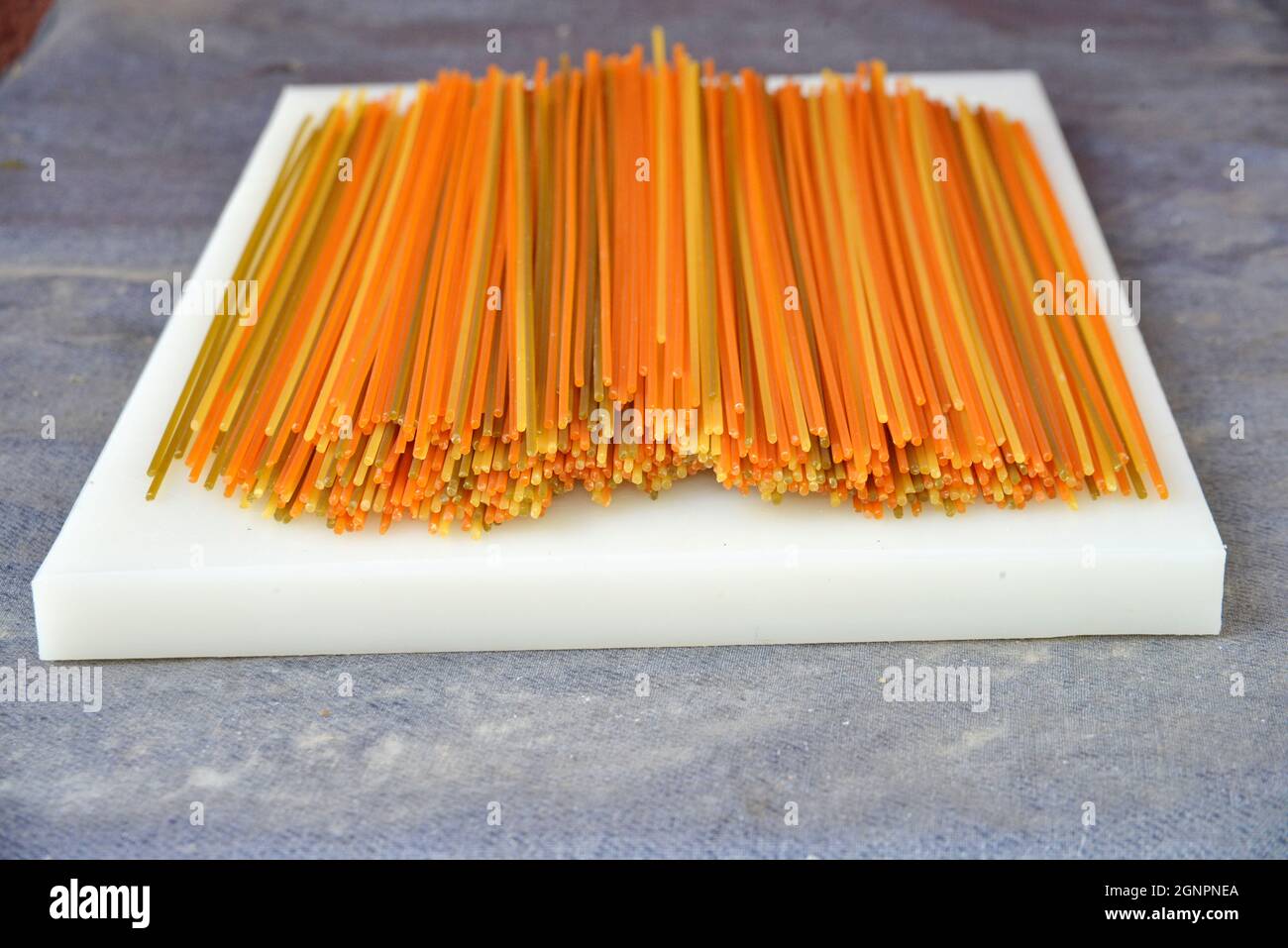 Spaghetti tricolore on white kitchen board Stock Photo - Alamy
