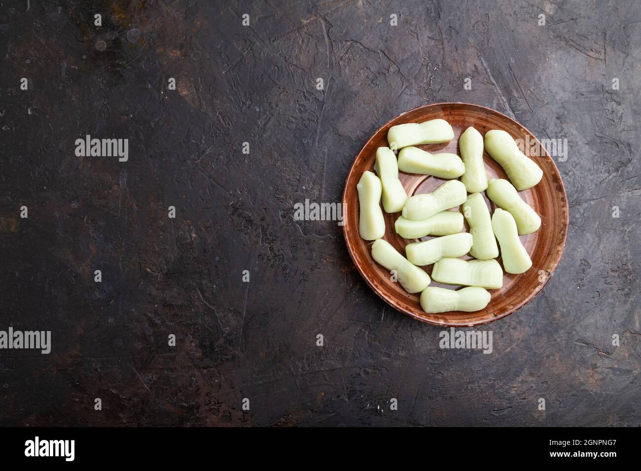 Jelly celery candies on black concrete background. copy space, top view ...