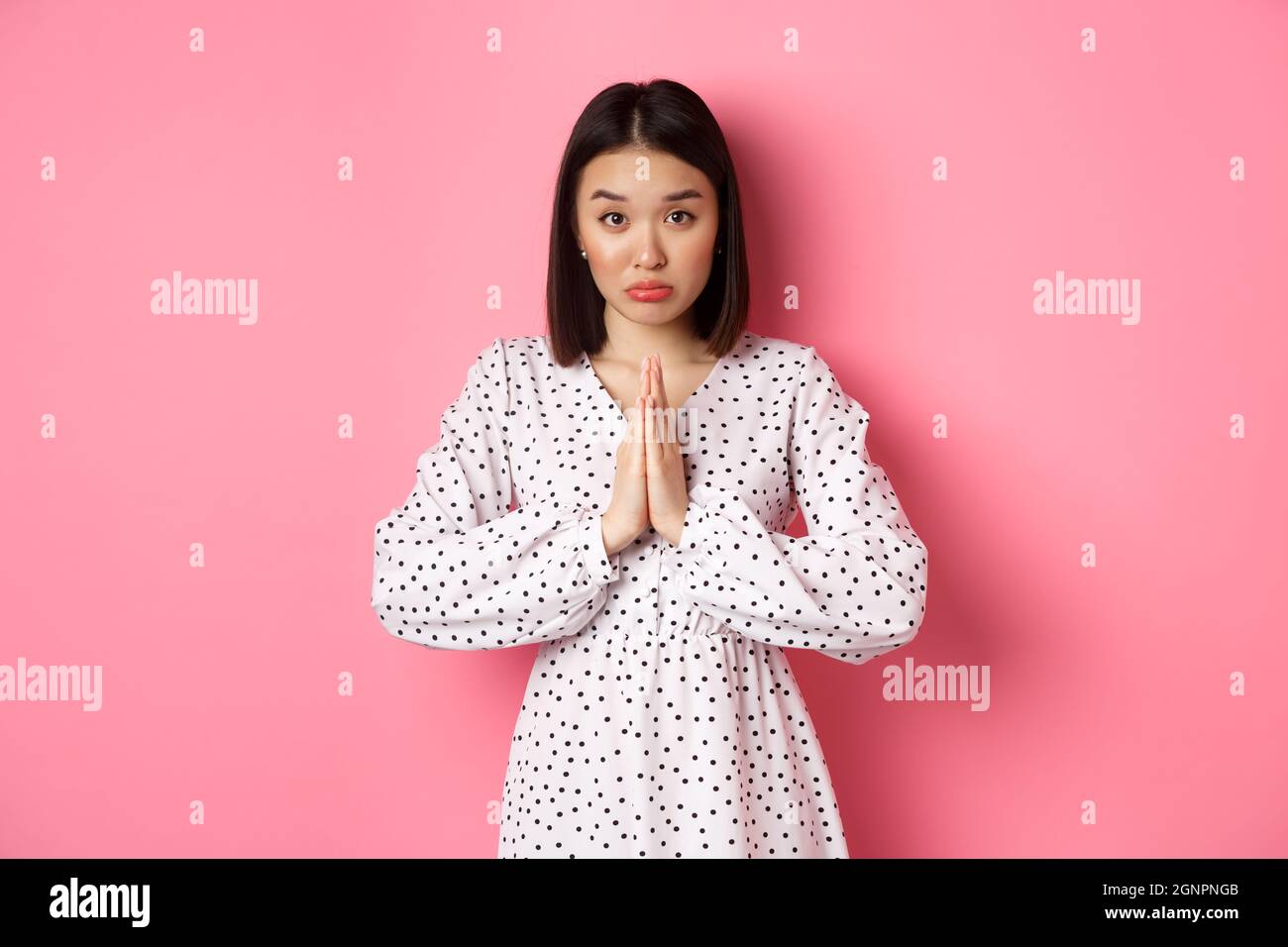 Cute asian girl asking for help, begging for favour and looking ...