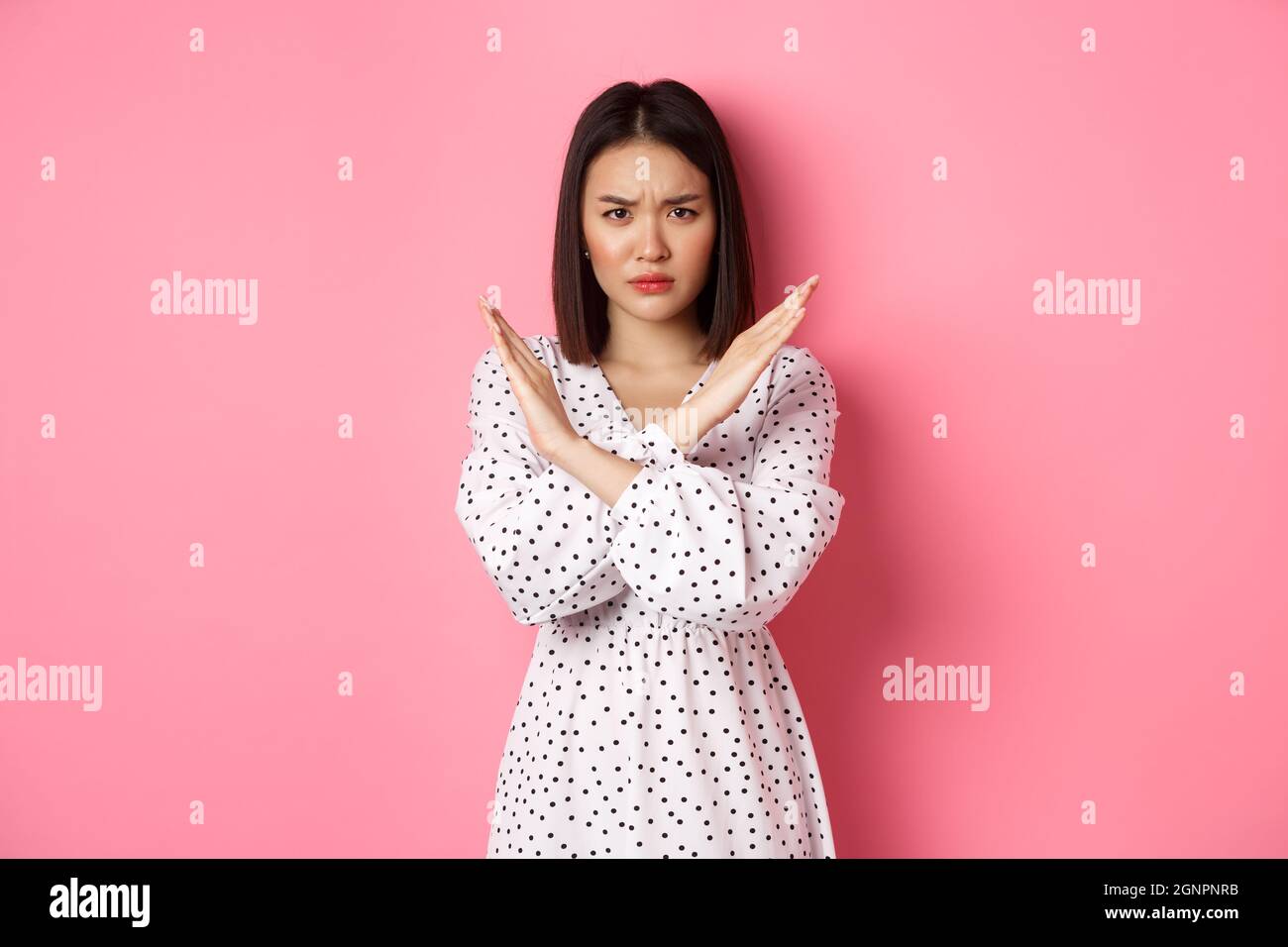 Angry asian woman tell stop, making cross to prohibit or disapprove ...