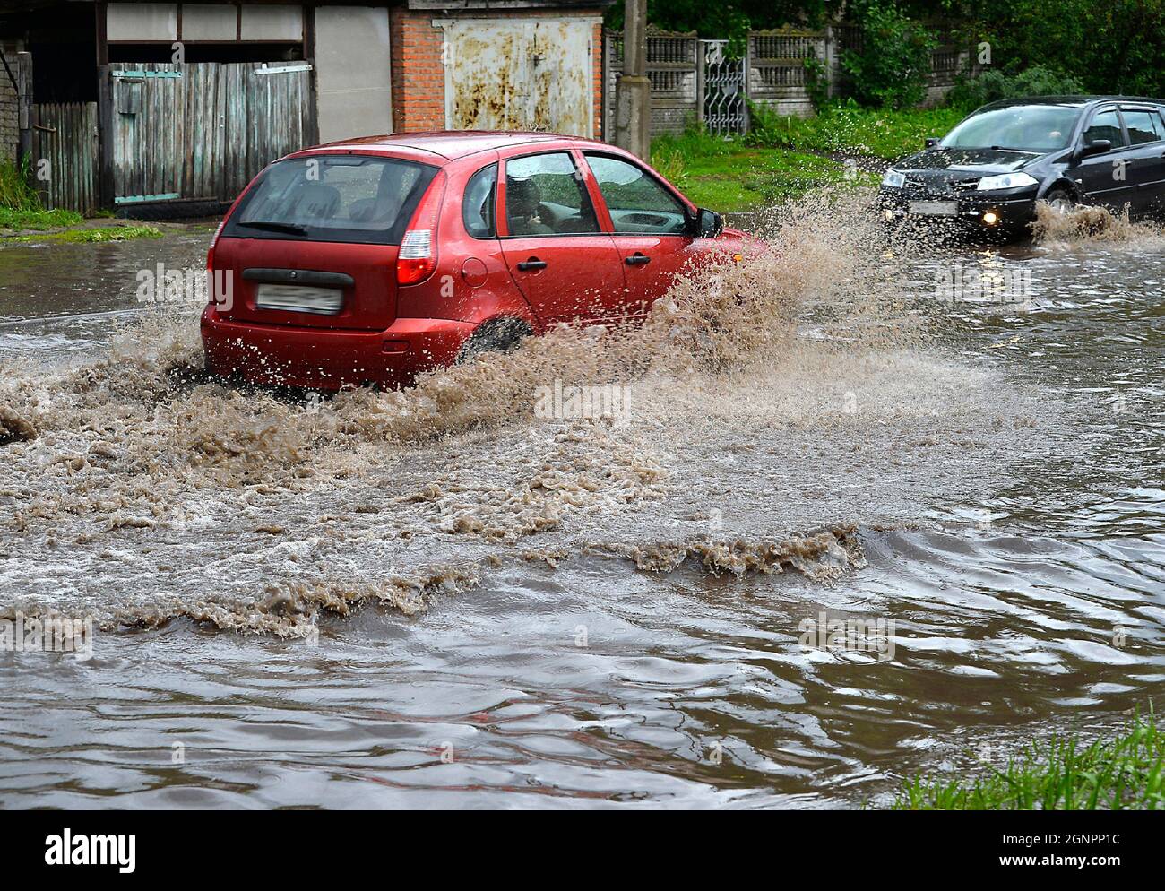 Cars drive in pouring rain on a flood-flooded road Stock Photo - Alamy