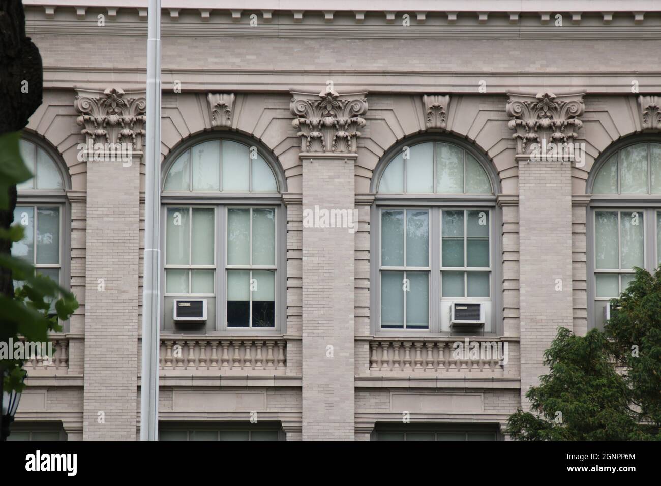 Facade of an old building with arched windows Stock Photo - Alamy