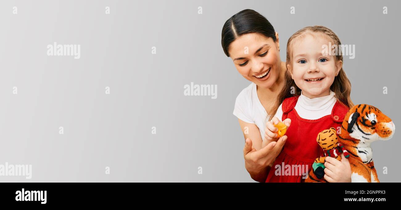 Child psychologist with little girl having fun during a psychotherapy ...