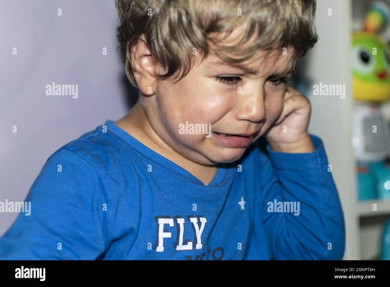 Little boy crying in frustration at not being able to do his homework ...