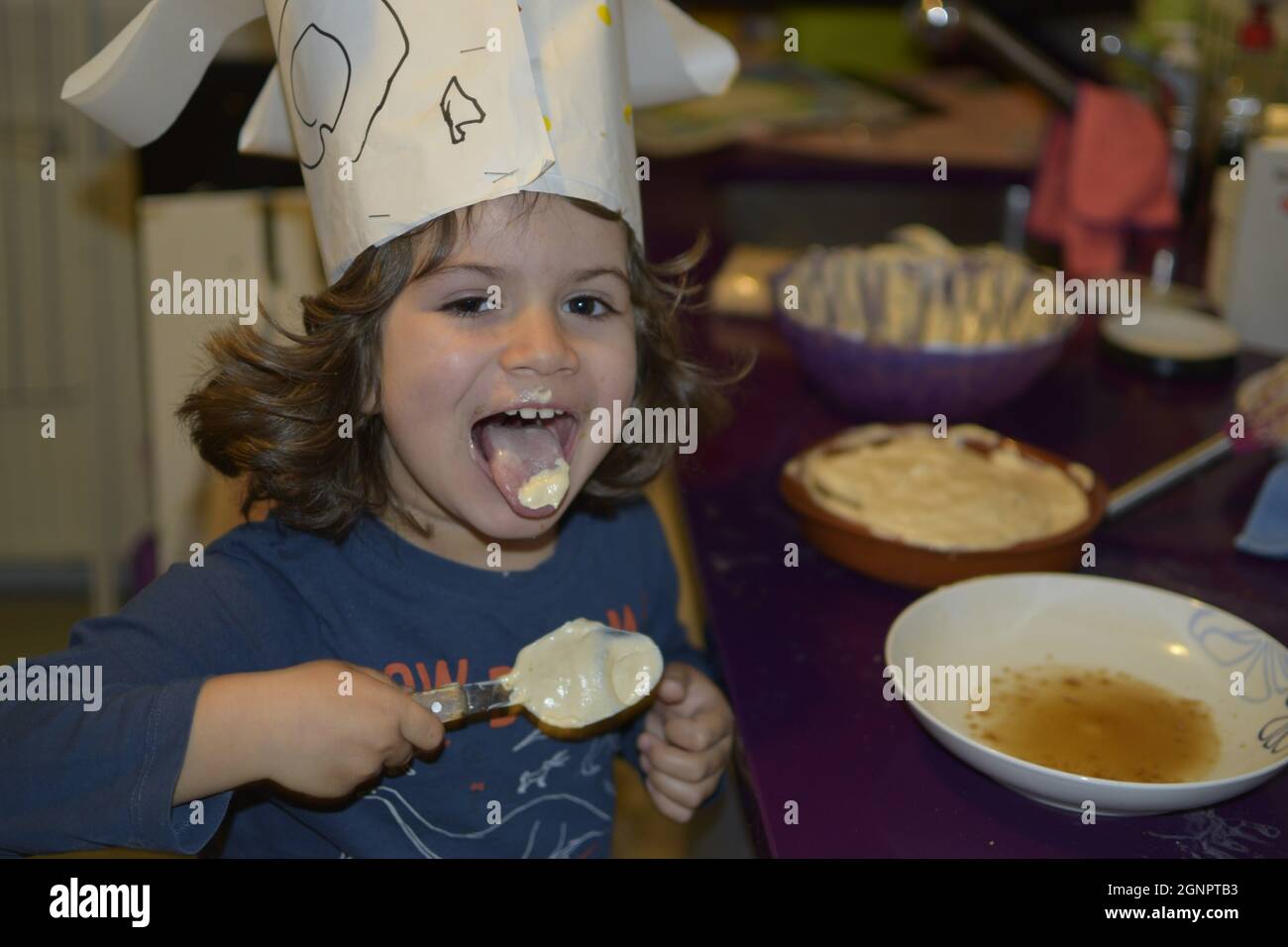 Boy tasting dough hi-res stock photography and images - Alamy