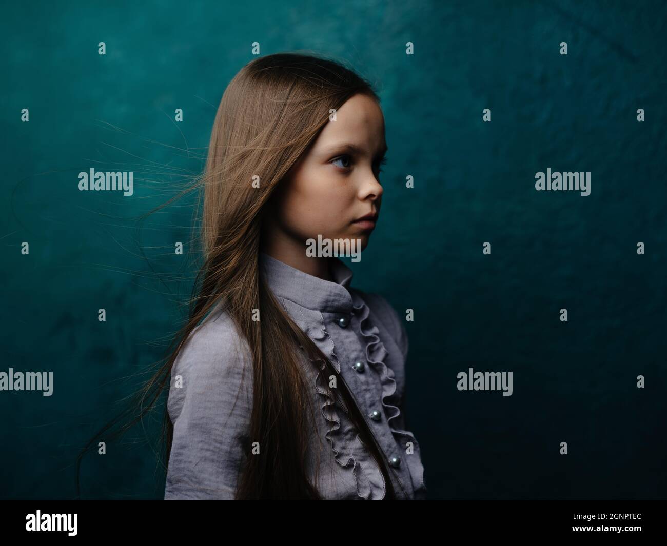 Girl in dress long hair studio green background close-up Stock Photo - Alamy