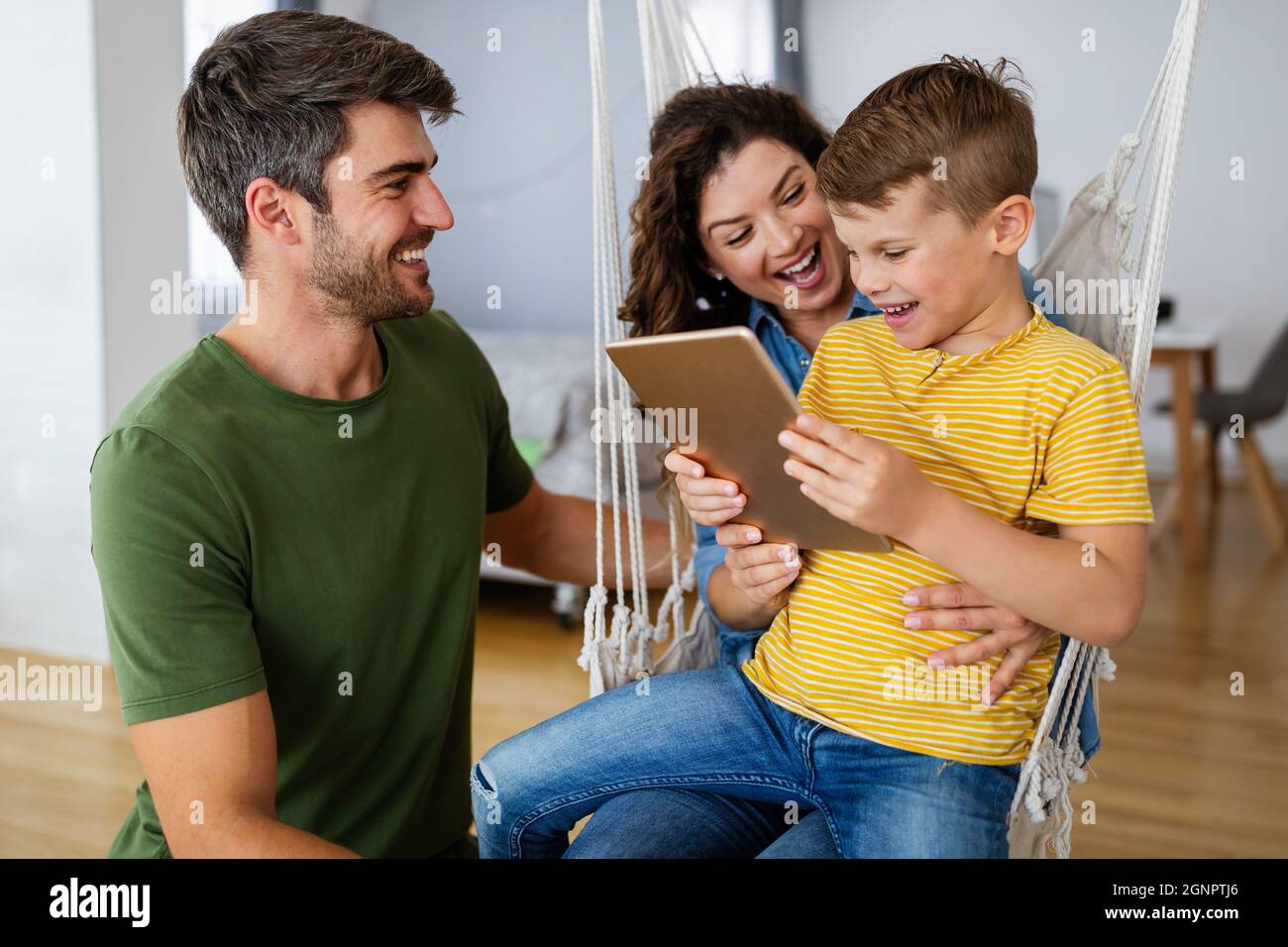 Happy family using technology devices together at home Stock Photo - Alamy