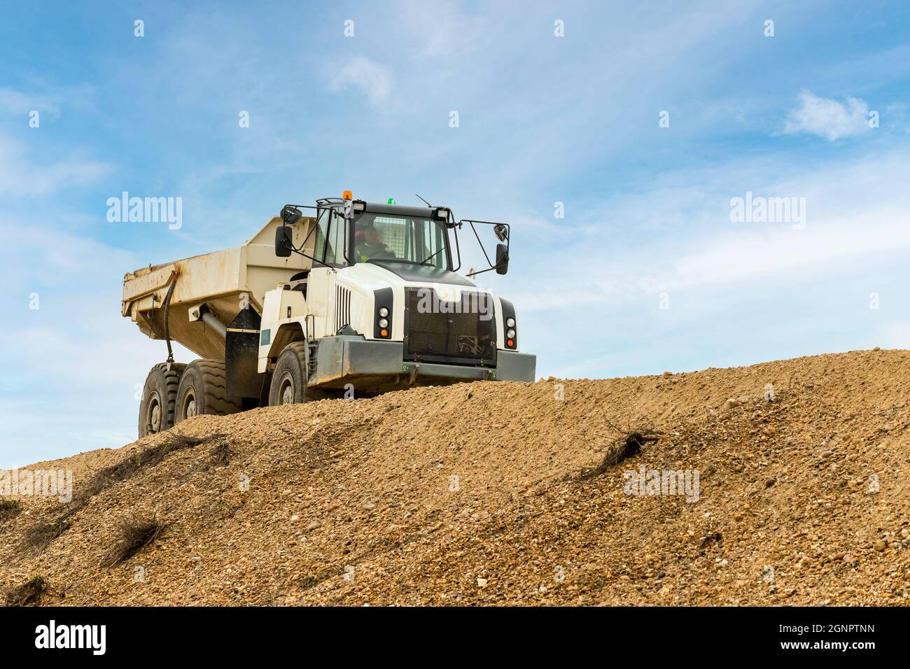 Articulated Dump Truck with load of shingle aggregate Stock Photo - Alamy