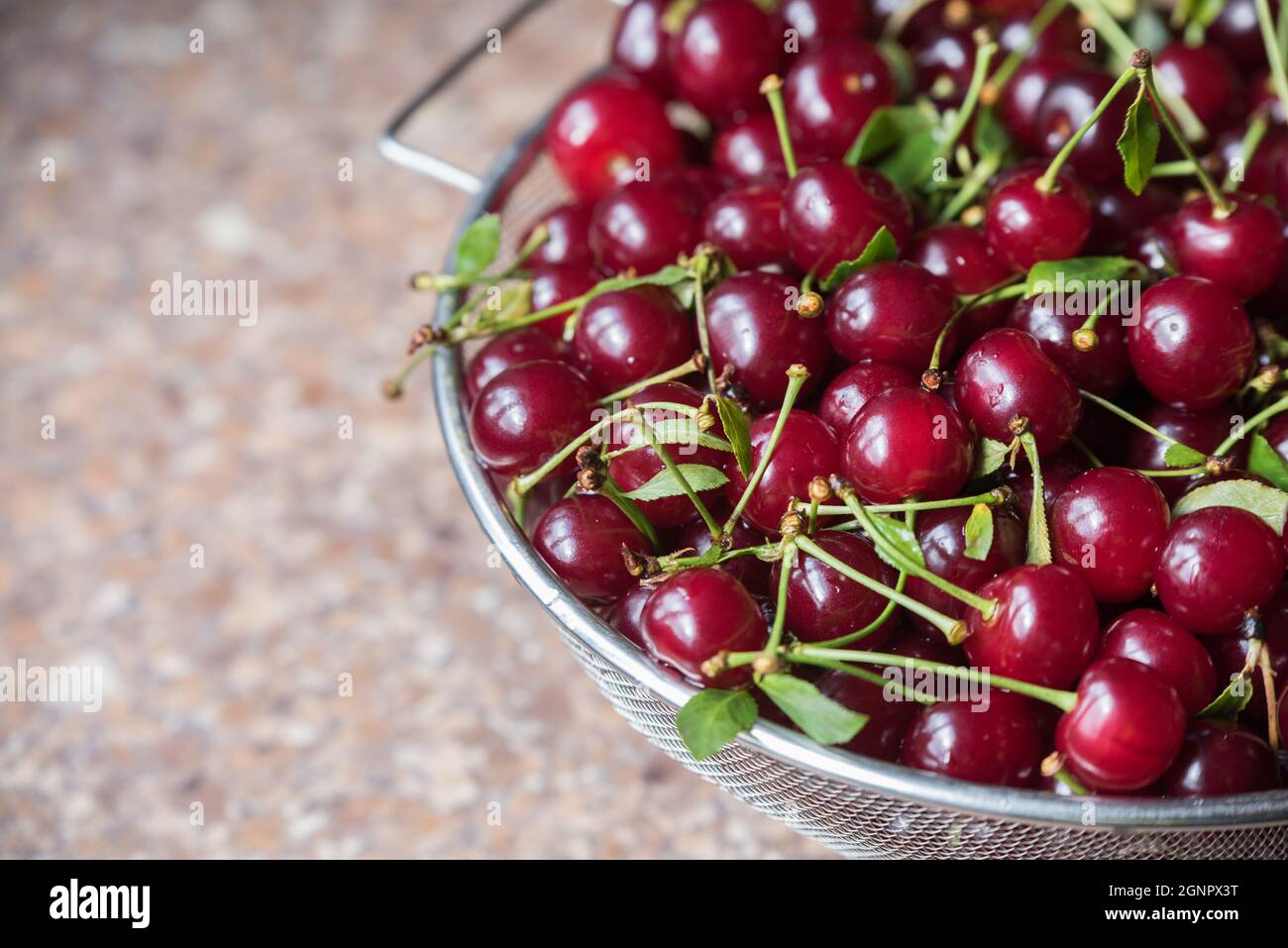 Cherries in a steel sieve. top view, texture Stock Photo - Alamy
