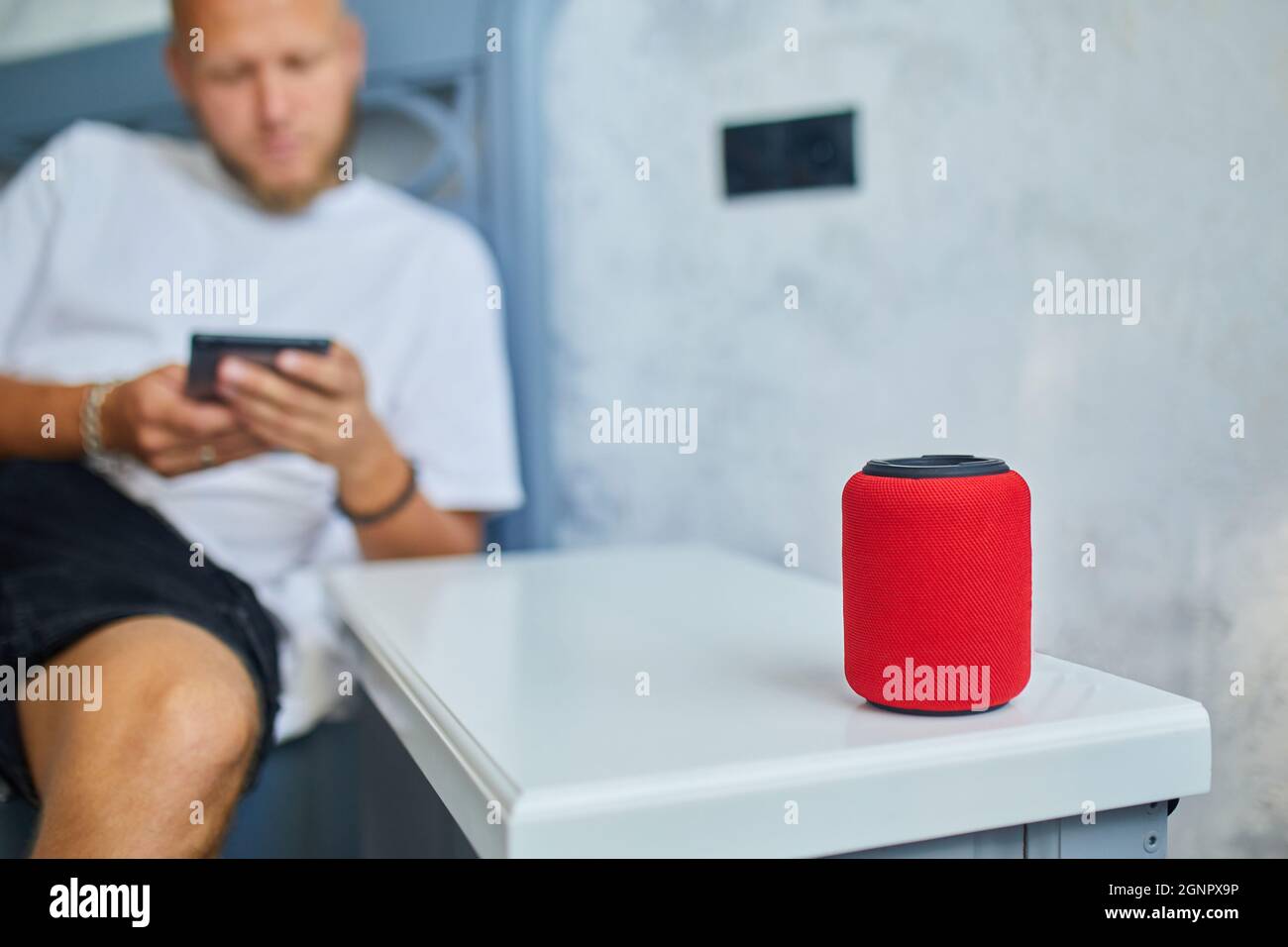 Male testing talking smart wireless speaker, man controlling home ...