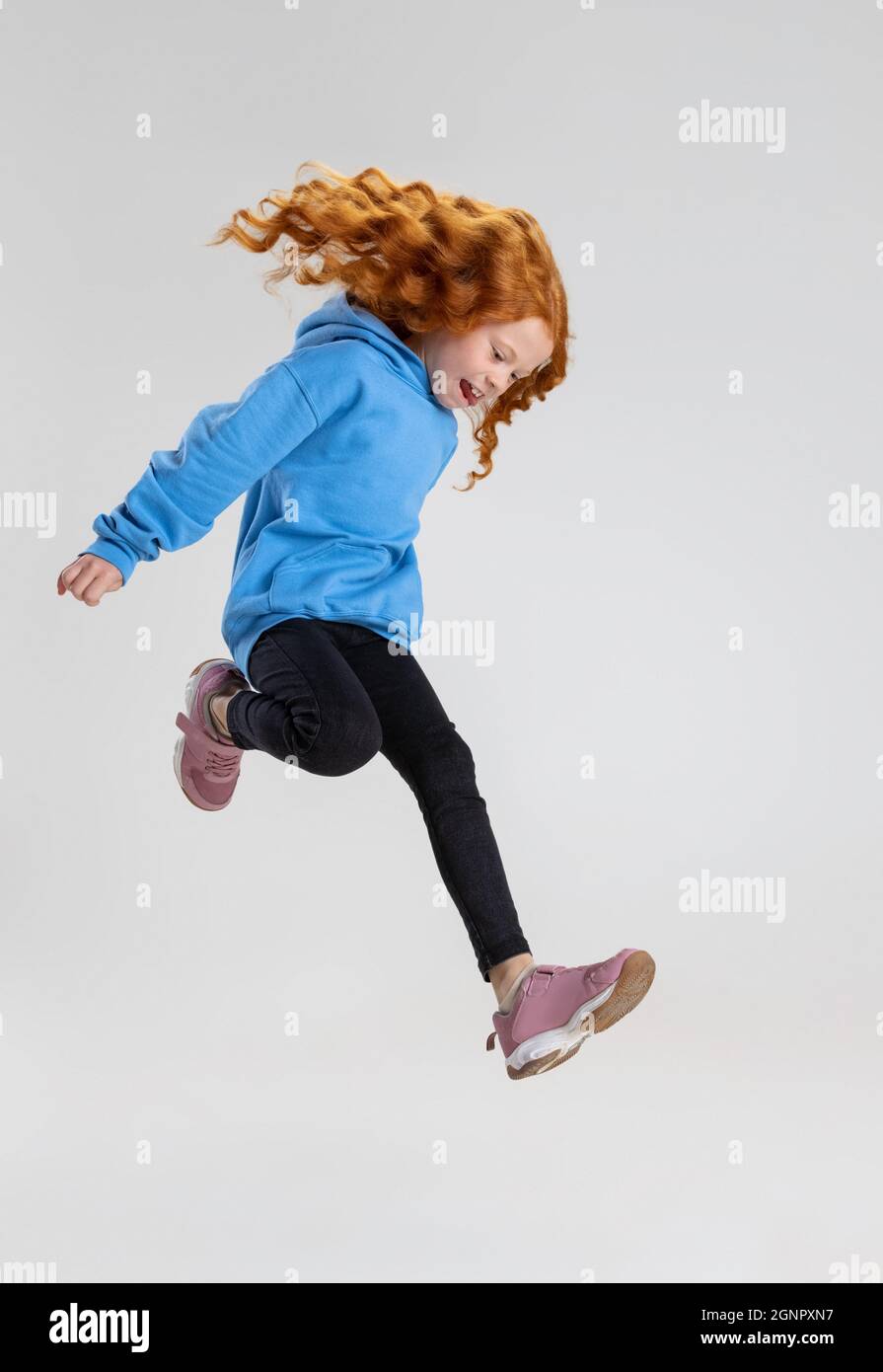 Full-length vertical portrait of little Caucasian girl, child posing in ...