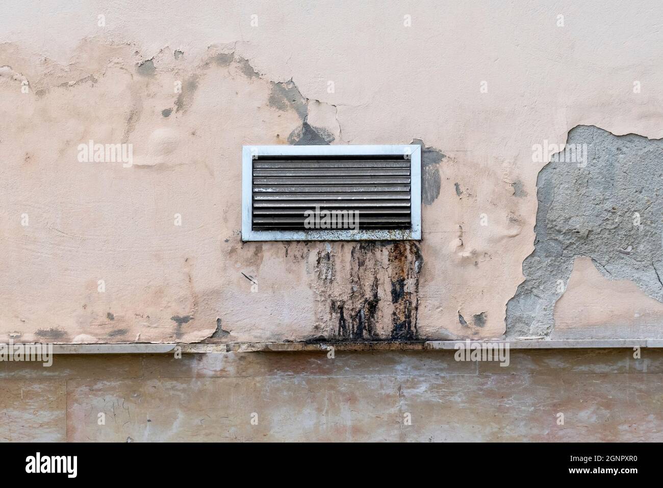 Dirty greasy exterior ventilation grill with dirt streaks on a peeled ...