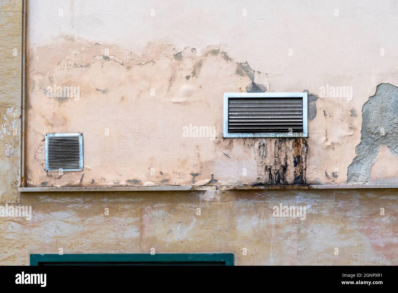 Dirty greasy exterior ventilation grill with dirt streaks on a peeled ...