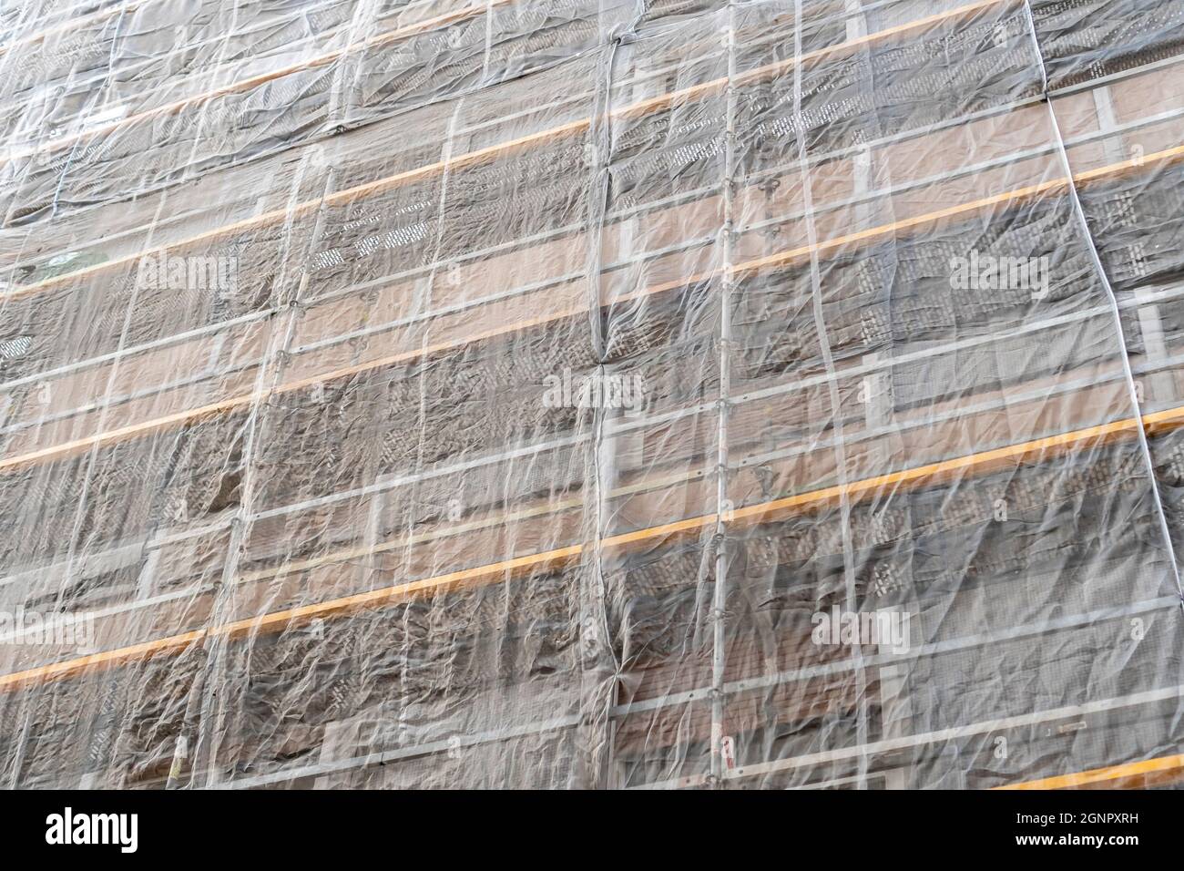 Construction site with a protective safety net on the facade of a ...