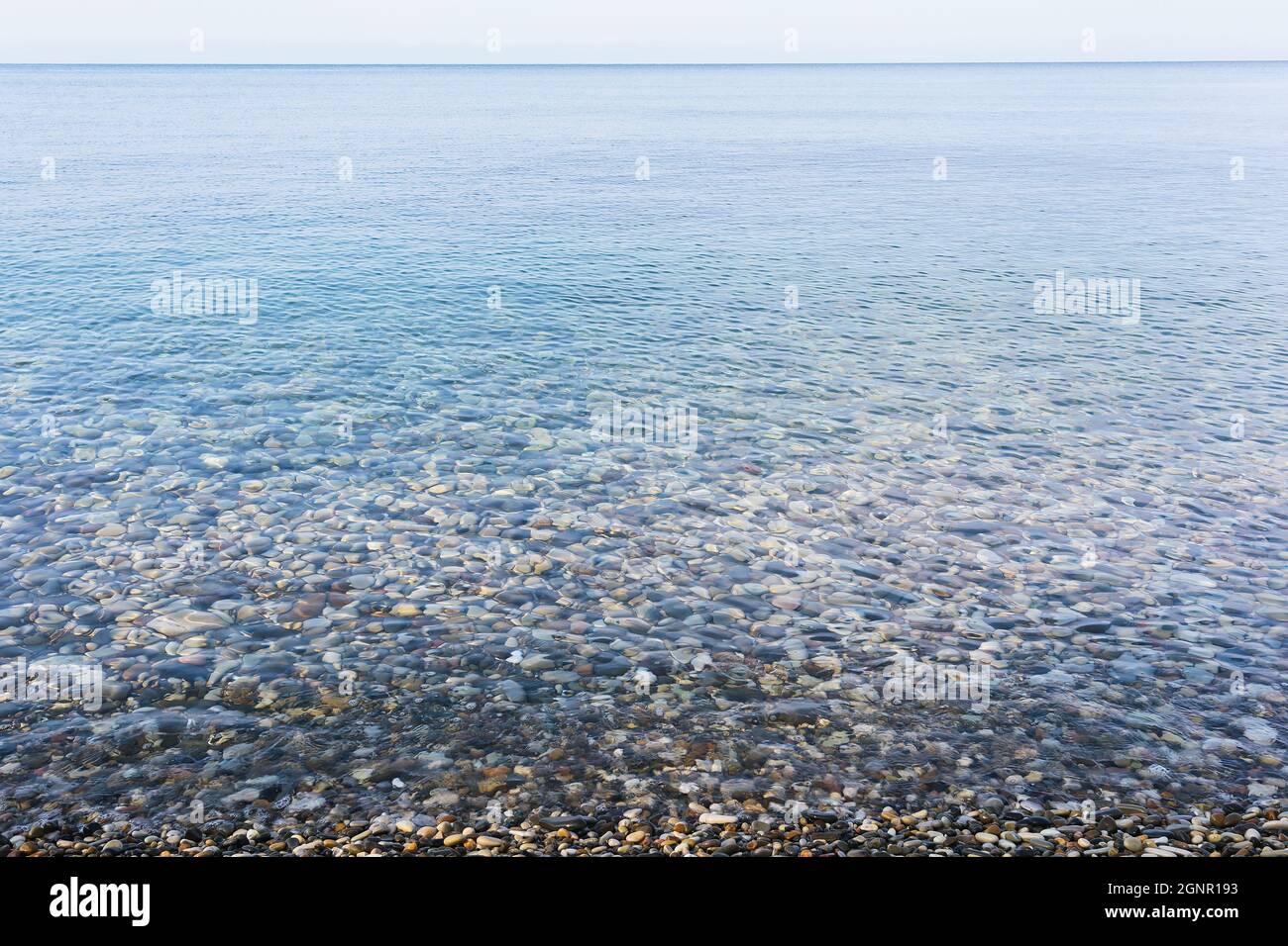 Calm sea with pebble bottom and clear water Stock Photo - Alamy