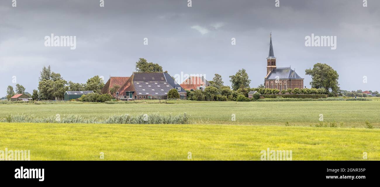 Dutch Hamlet of Warstiens with church and several farm barns in dairy ...