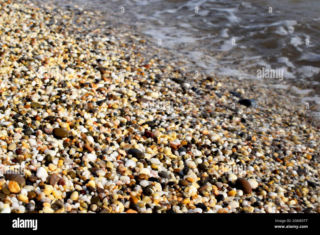 Natural texture background, colorful sea stones in water, top view ...