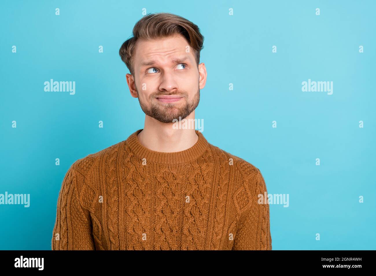 Photo of doubtful young minded man look empty space think idea plan ...
