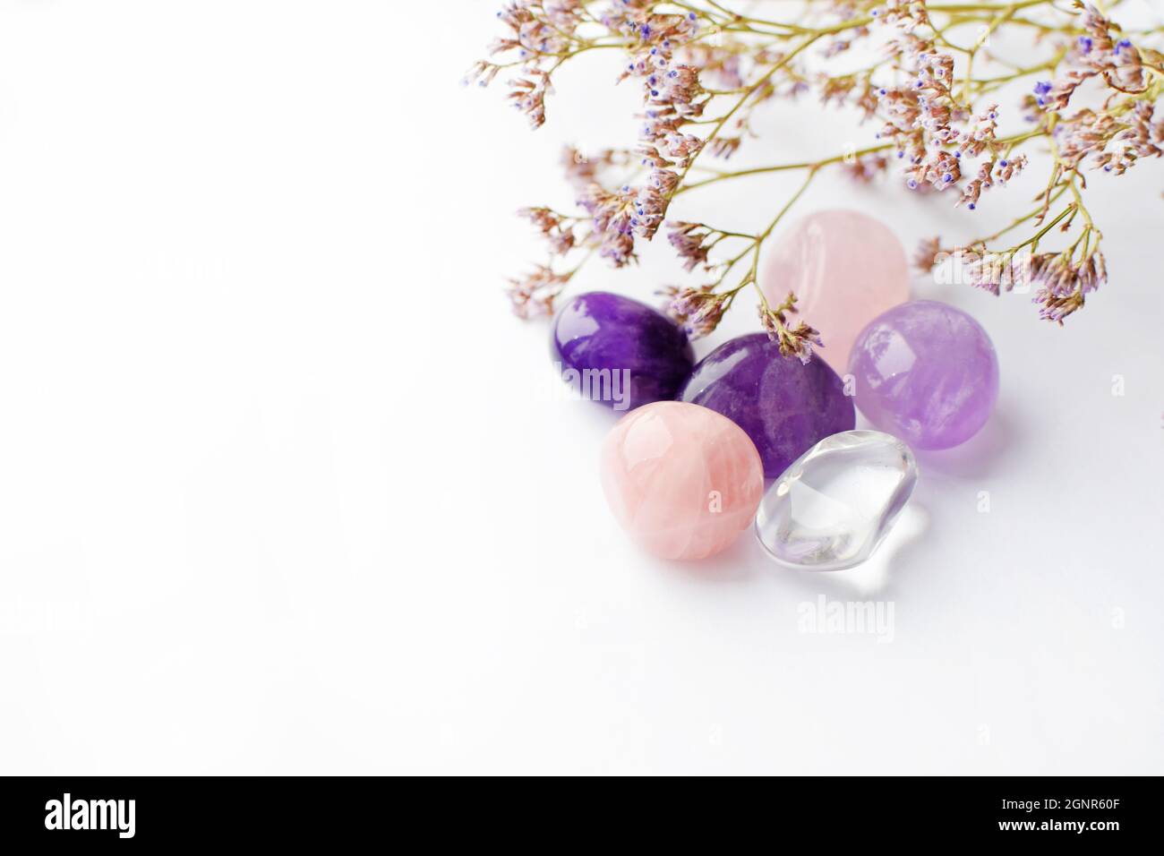 Beautiful amethyst crystals and round rose quartz stone with dry ...