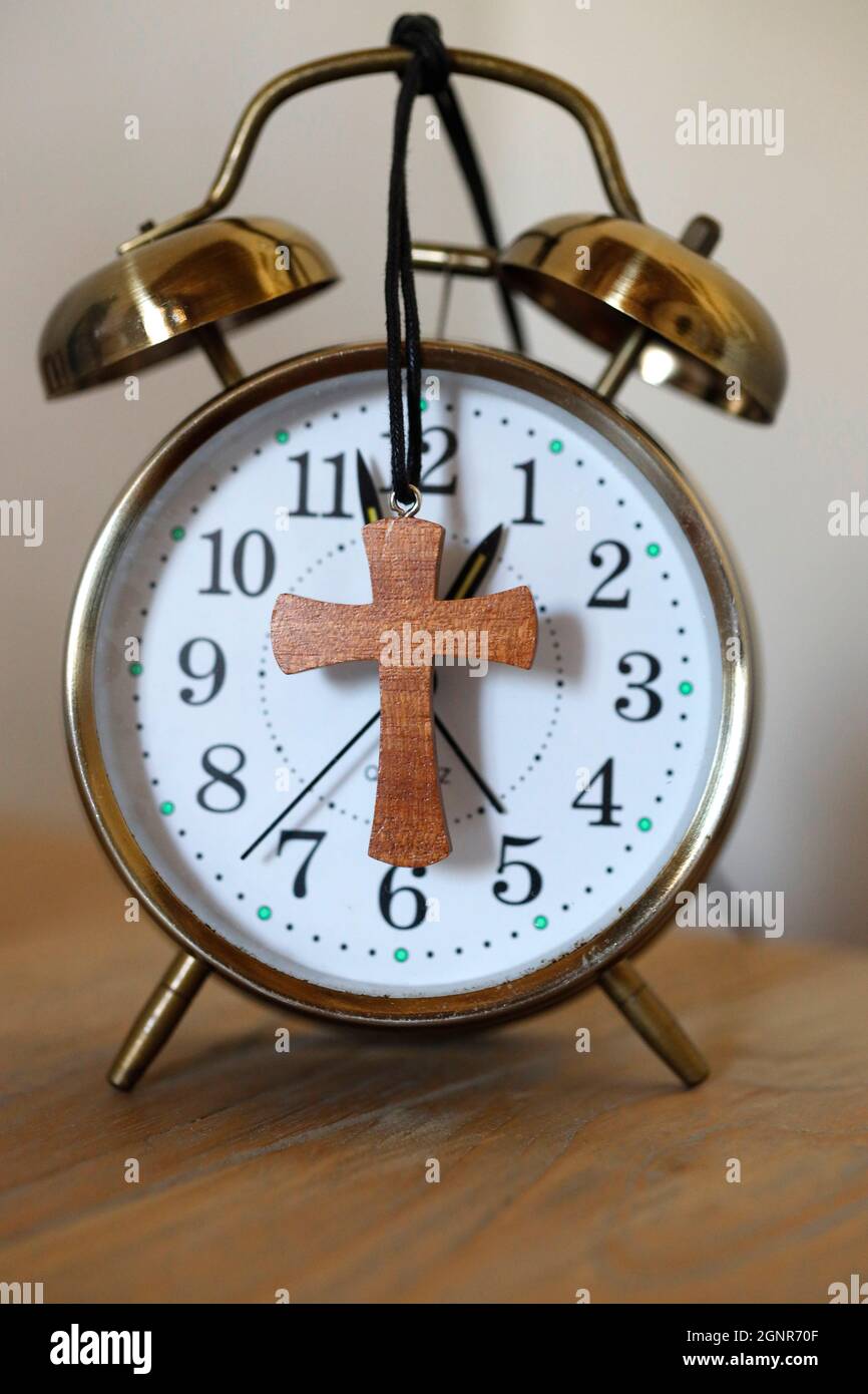 Old-fashioned vintage copper alarm clock with christian cross Stock ...