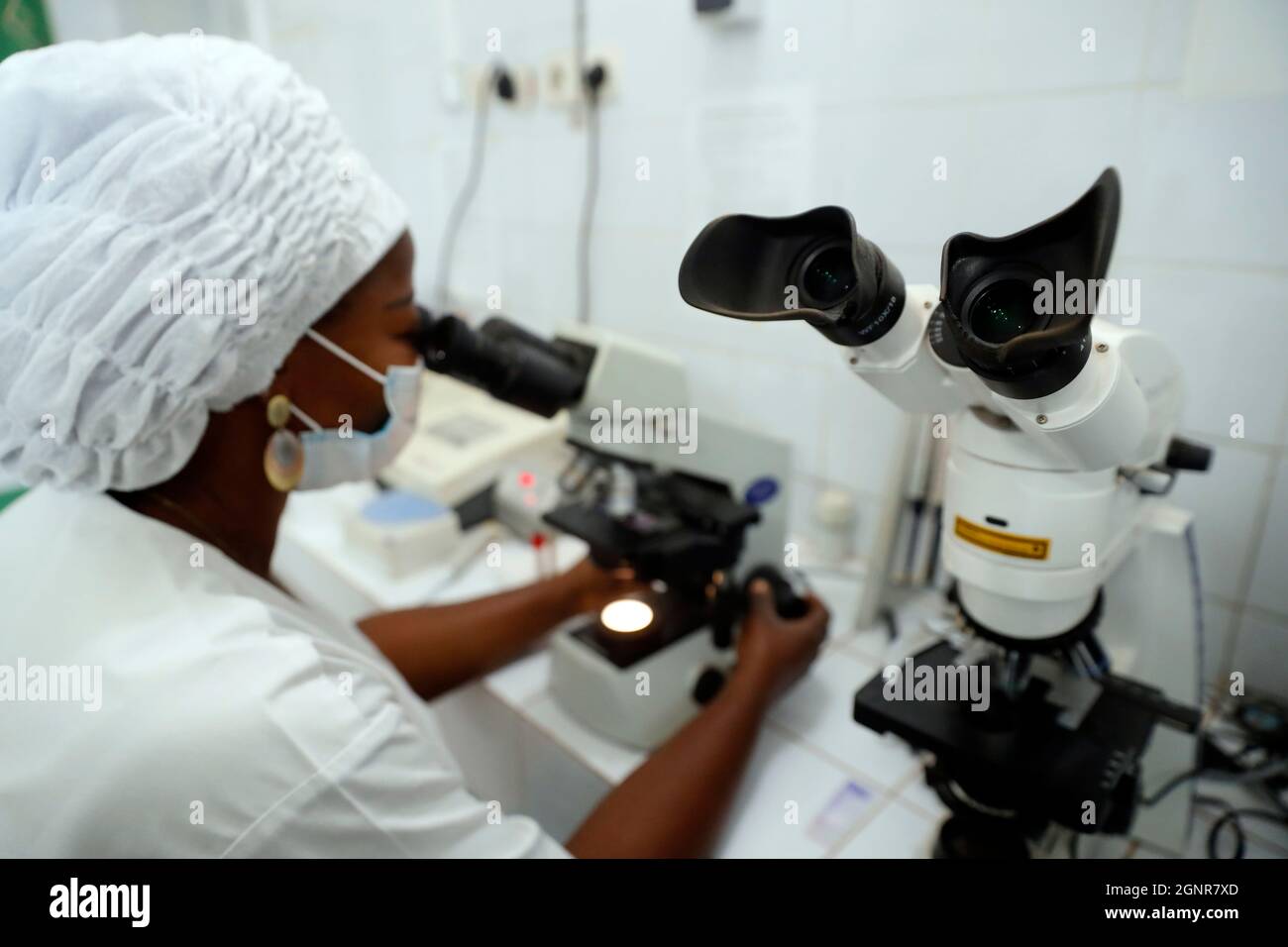 Biology in an African hospital. A laboratory technician testing blood ...