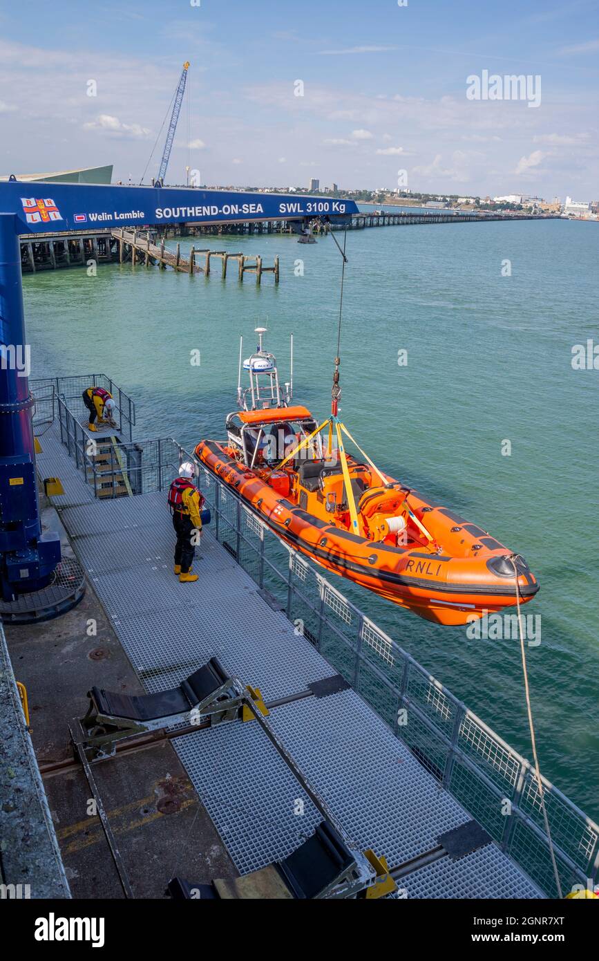 RNLI lifeboat being hoisted up to the lifeboat station on the end of ...