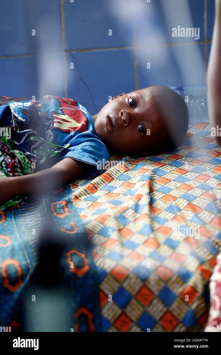 African hospital. Pediatric ward. Young patient in bed. . Benin Stock ...