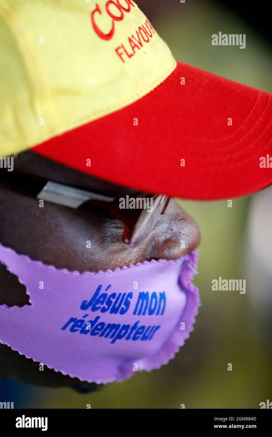 Covid-19 pandemic in Africa. Christian wearing a mask with the name of ...