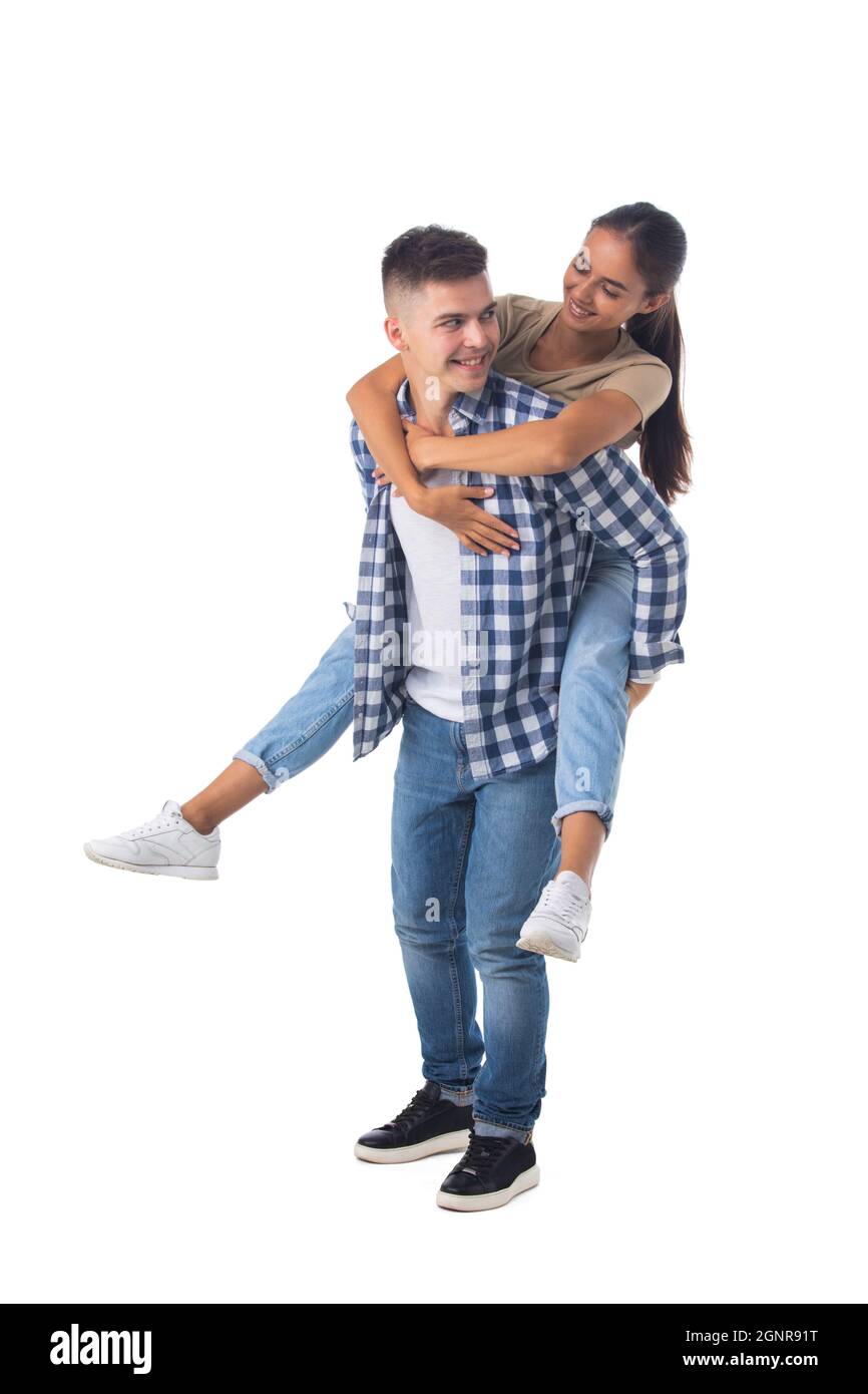 Laughing teen playful couple piggyback ride isolated white background ...