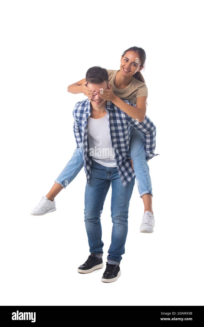 Laughing teen playful couple piggyback ride isolated white background ...