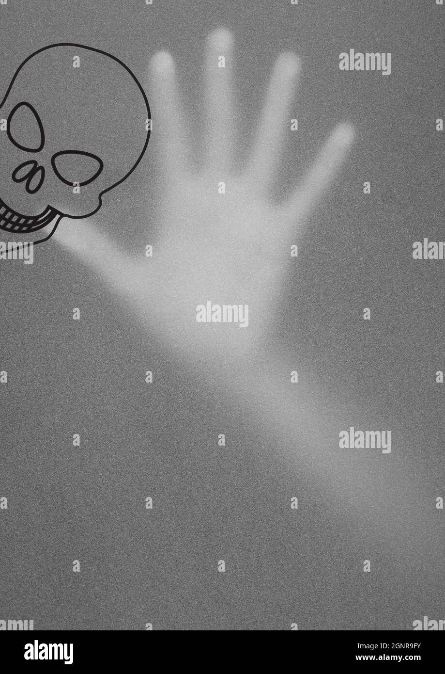 Human skull icon and noise effect overlay over trapped hand against ...