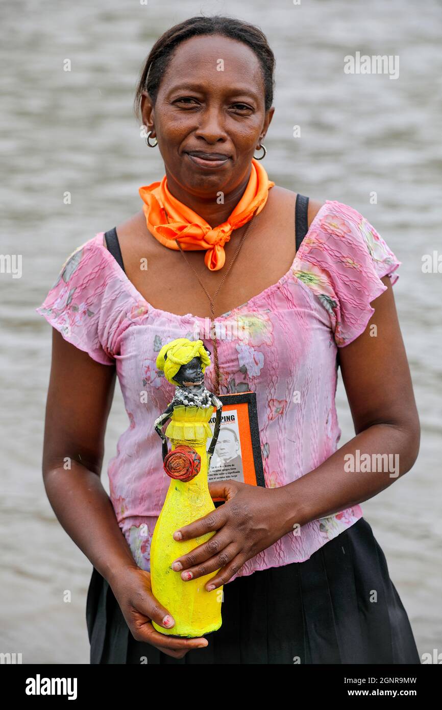 Afro-Ecuadorian woman holding a traditionnal puppet in Valle del Chota ...