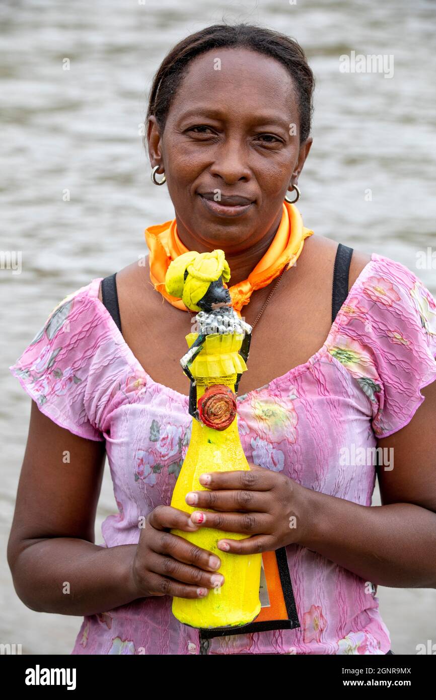 Afro-Ecuadorian woman holding a traditionnal puppet in Valle del Chota ...