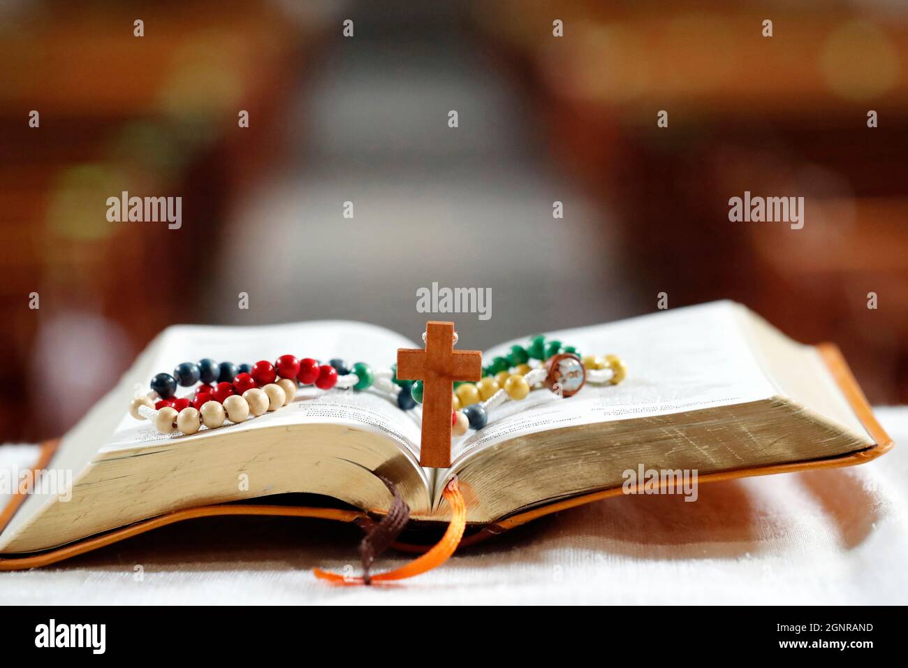 Rosary and open bible on altar. Catholic church. France Stock Photo - Alamy