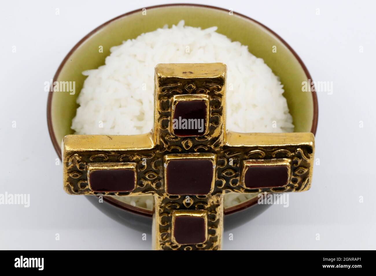 Christian cross and bowl of rice during Lent. A solemn religious ...