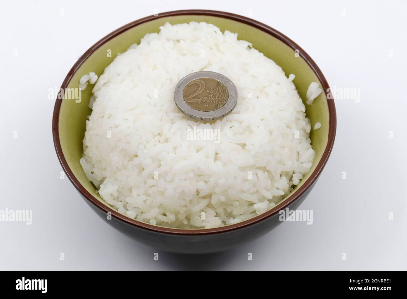 Money and food concept. Coin on a bowl of steamed white rice Stock ...