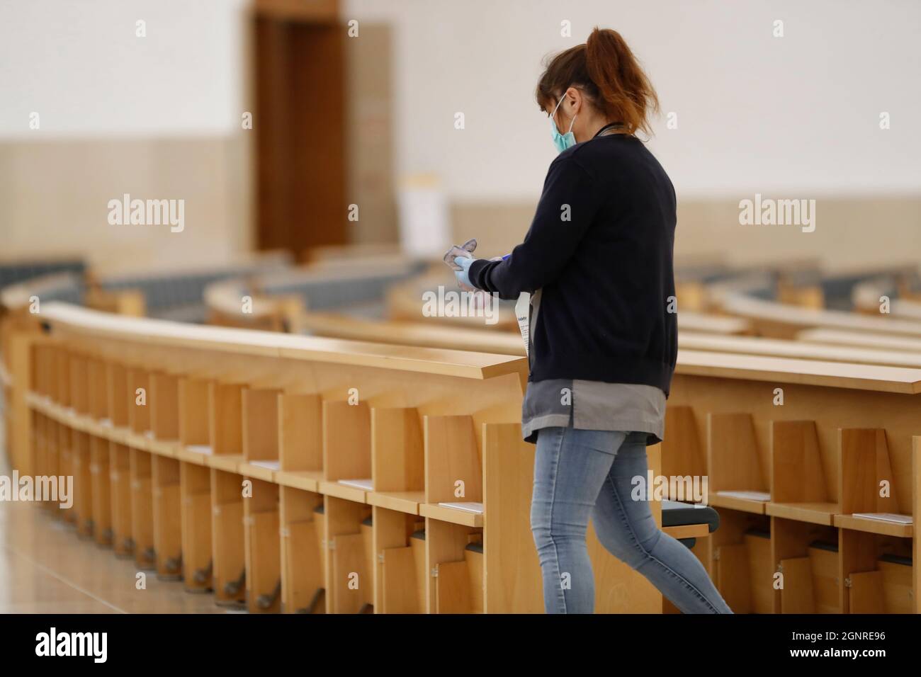 Basilica of the Holy Trinity. Covid-19 pandemic. Woman cleaning the ...